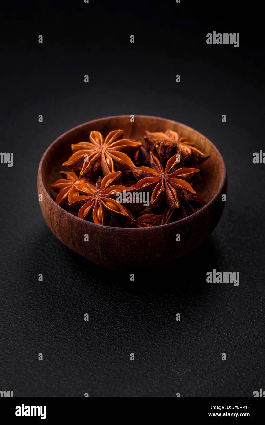 Star shaped spice star anise in a wooden round bowl Stock Photo - Alamy
