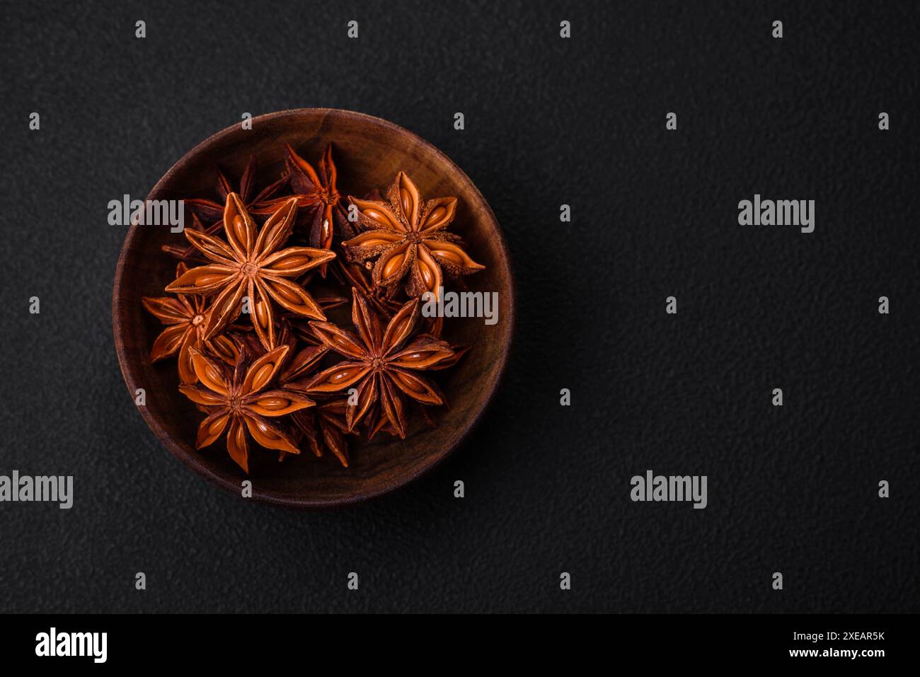 Star shaped spice star anise in a wooden round bowl Stock Photo - Alamy