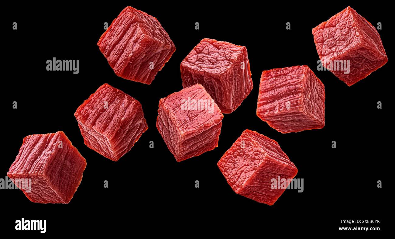 Raw beef cubes isolated on black background Stock Photo - Alamy
