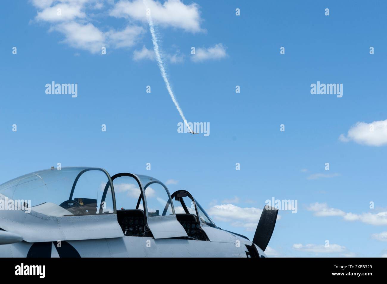 Open plane cockpit and vapor trail from plane in sky above.Tauranga ...