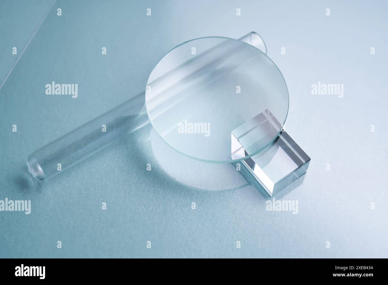Glass objects and prisms on a blue background Stock Photo - Alamy