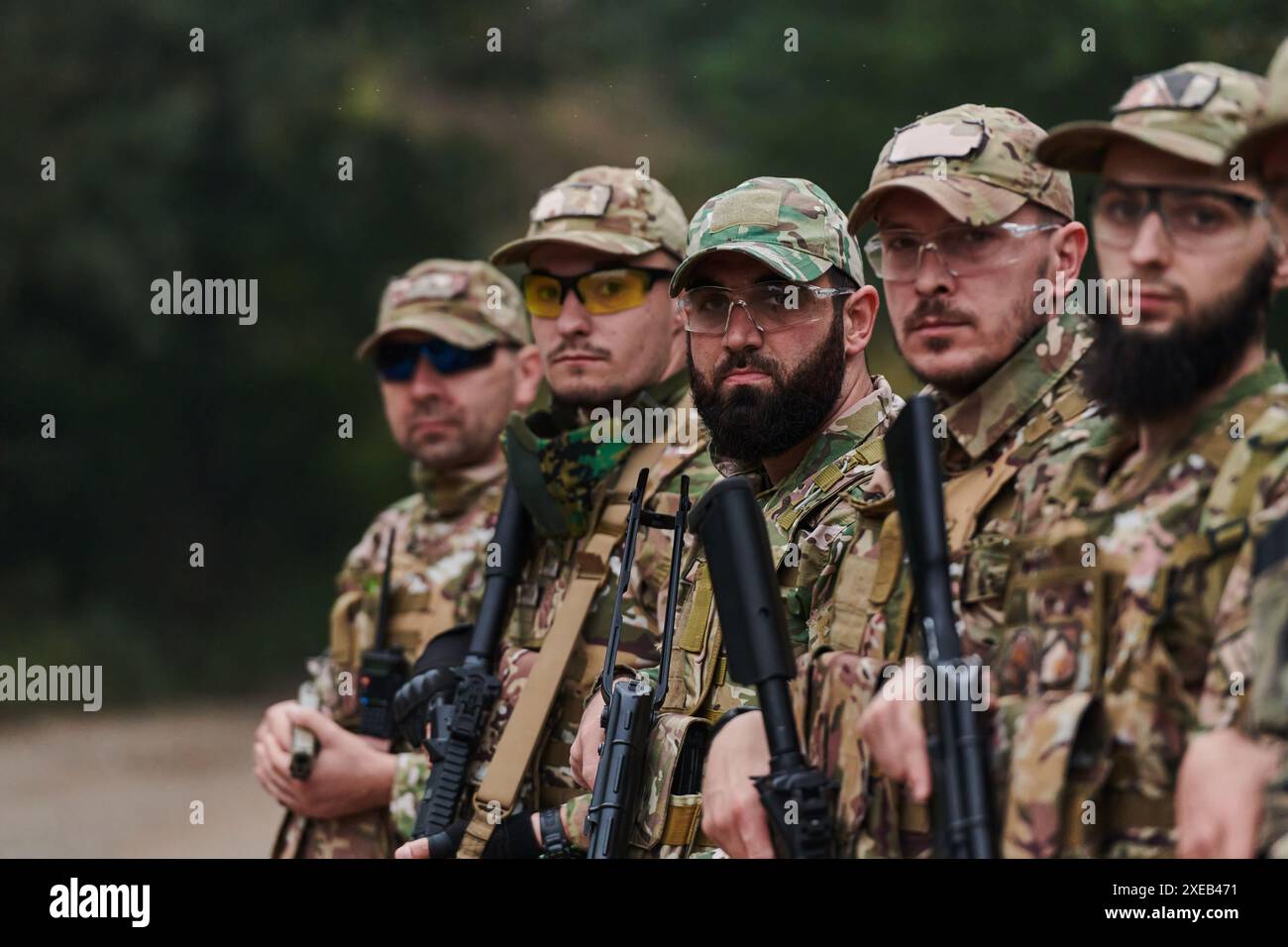 Soldier fighters standing together with guns. Group portrait of US army ...