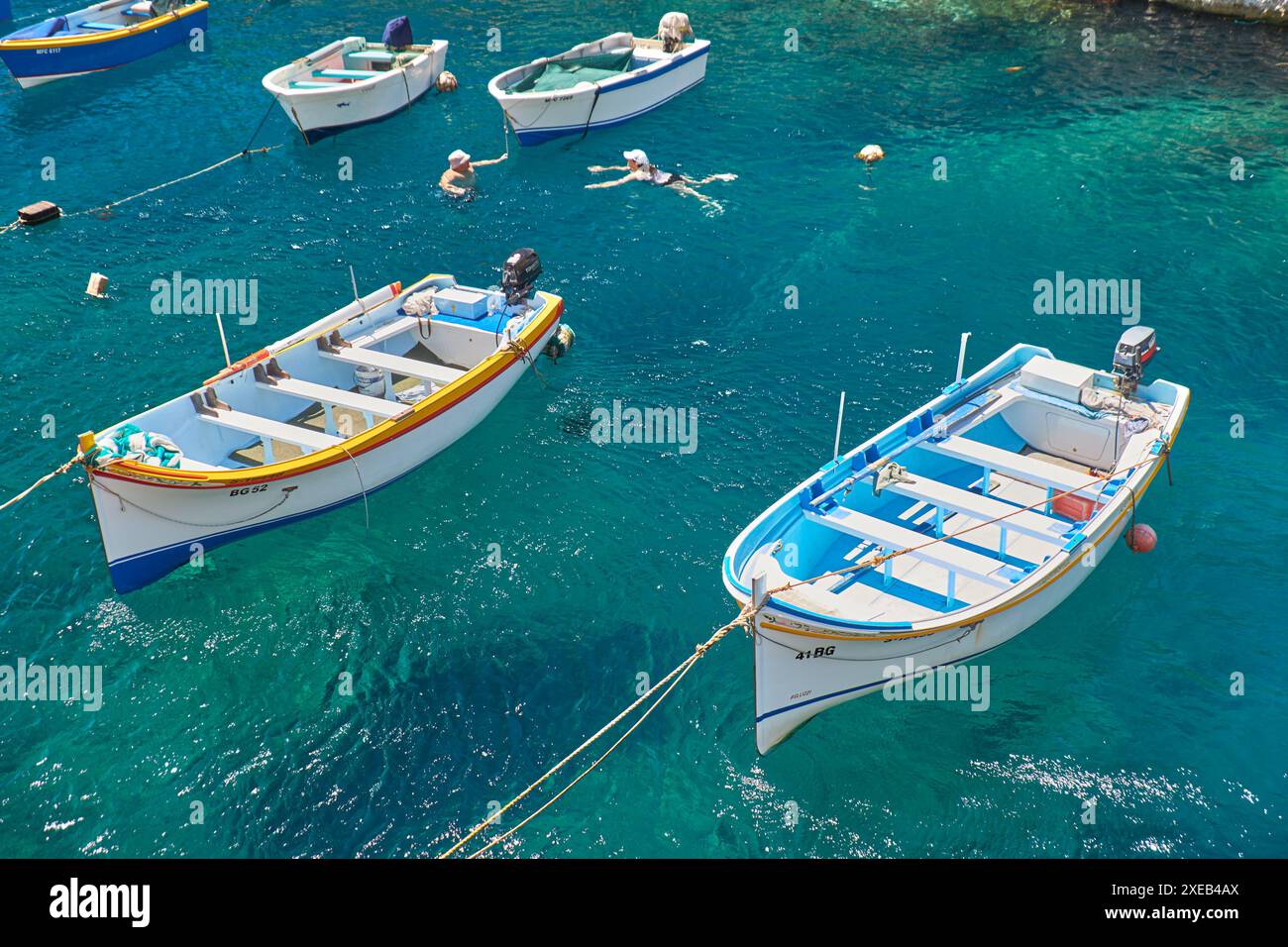 Maltese boats on transparent green water of Wied Zurrieq Fjord of Malta ...