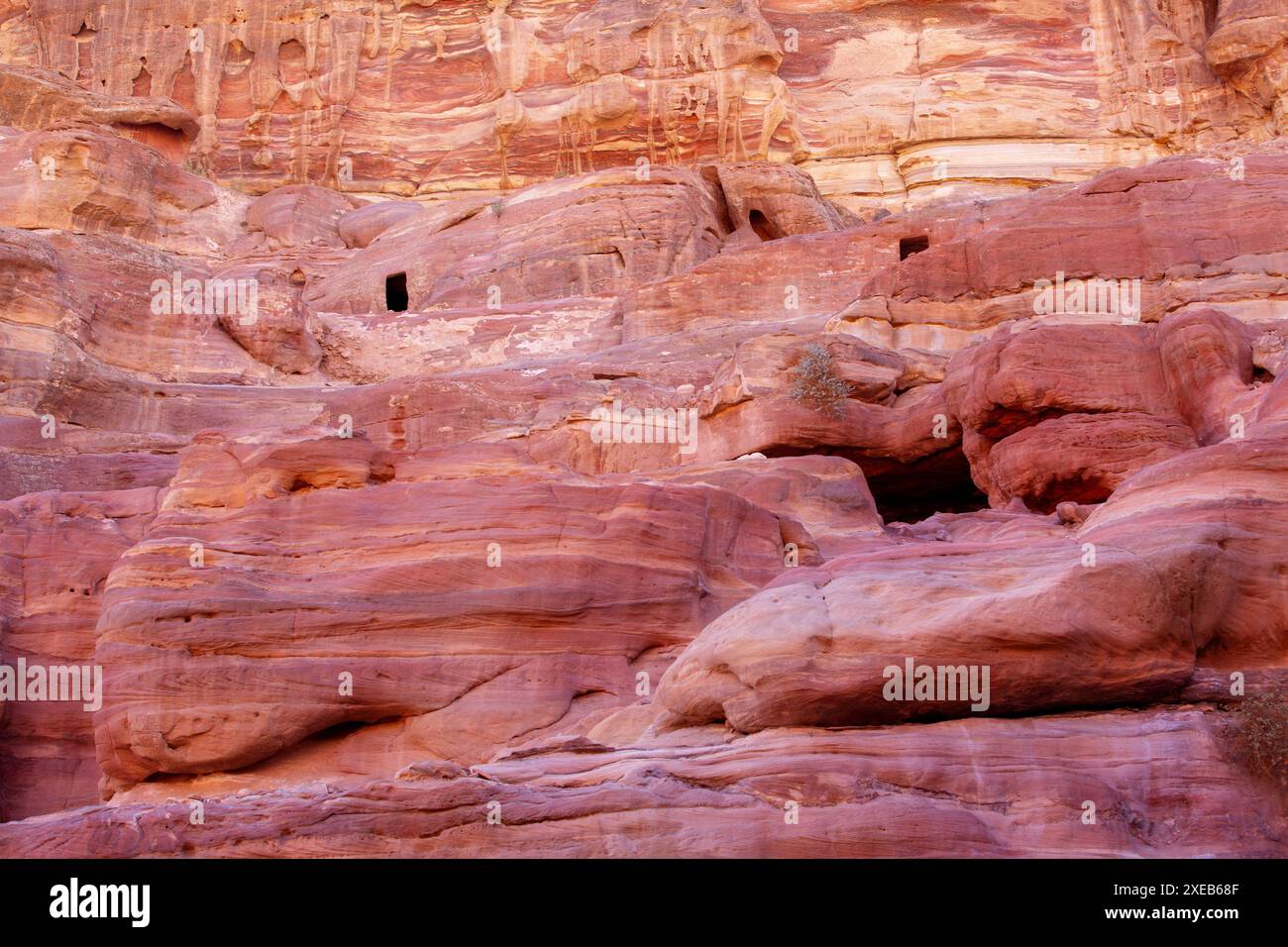 Red rocks caves, canyon of Petra, Jordan Stock Photo - Alamy