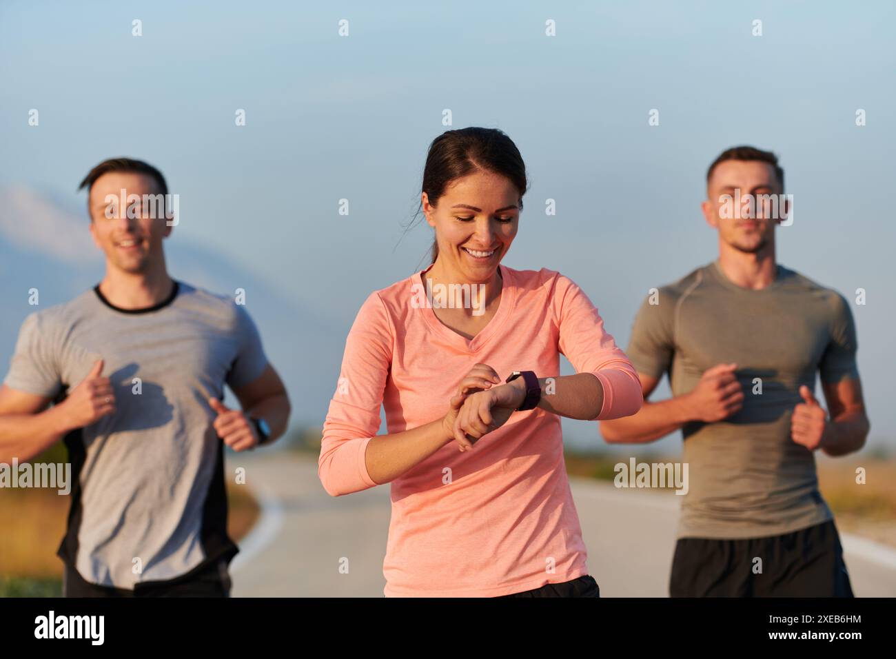 A group of friends, athletes, and joggers embrace the early morning ...