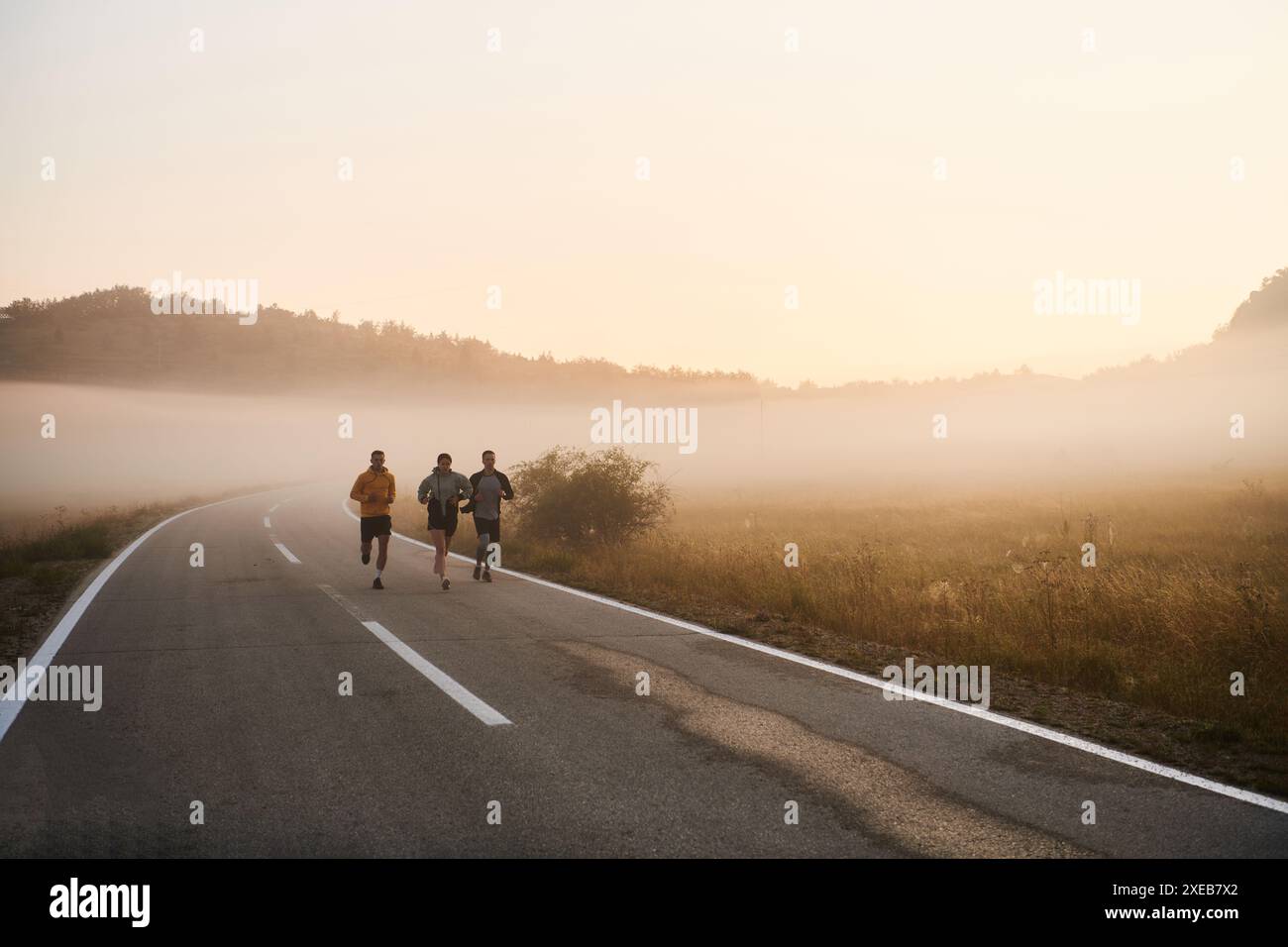 A group of friends, athletes, and joggers embrace the early morning ...