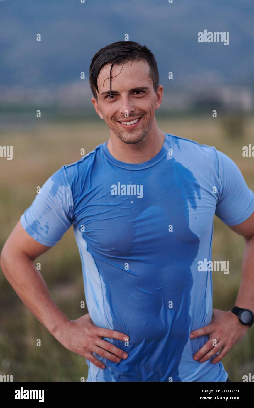 After completing a grueling daily run, a sweaty athlete takes a well ...