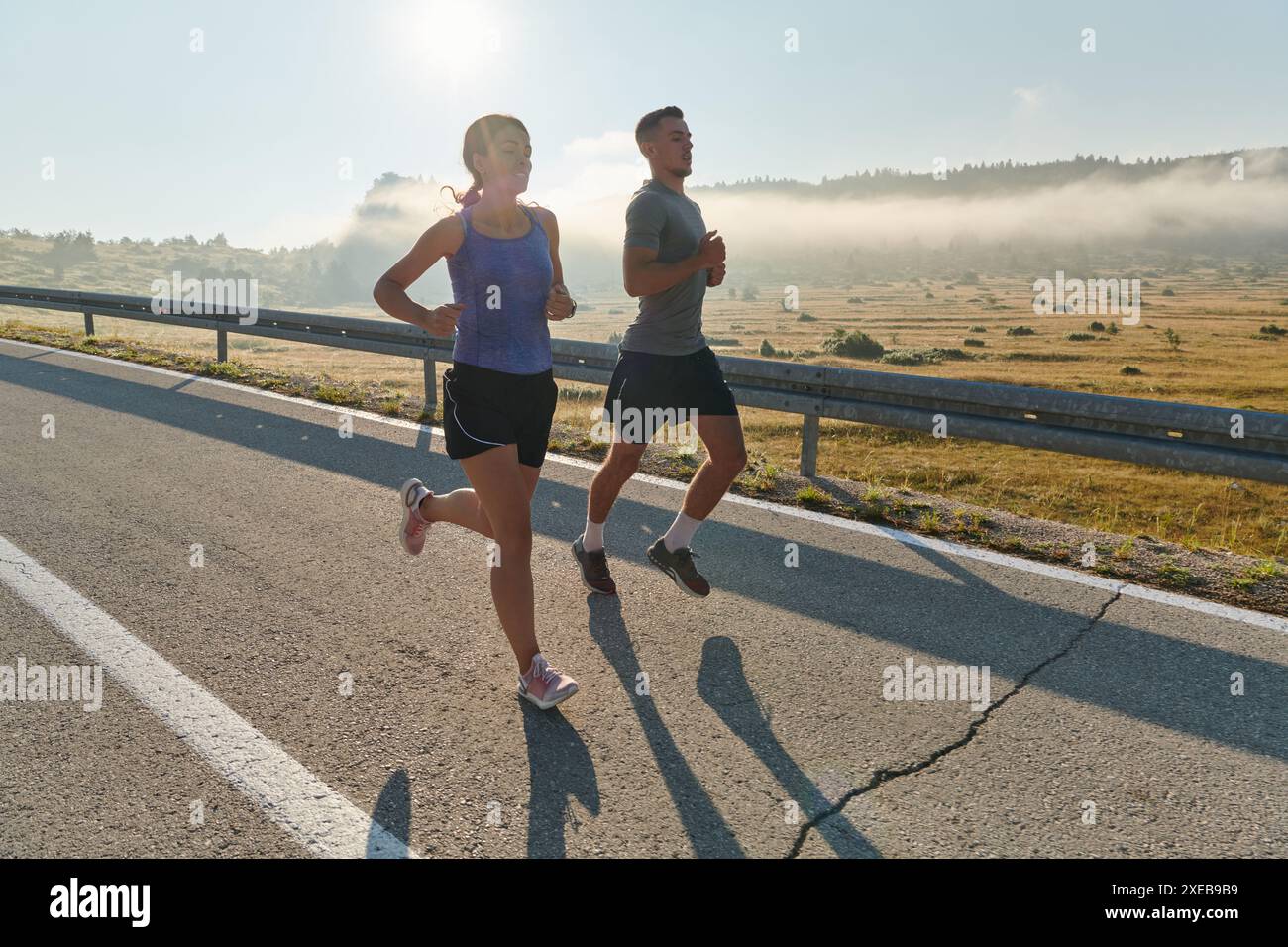 A couple runs through a sun-dappled road, their bodies strong and healthy, their love for each ...