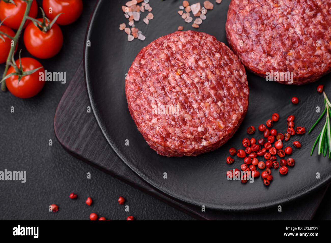 Fresh raw ground beef burger patty with salt and spices Stock Photo - Alamy