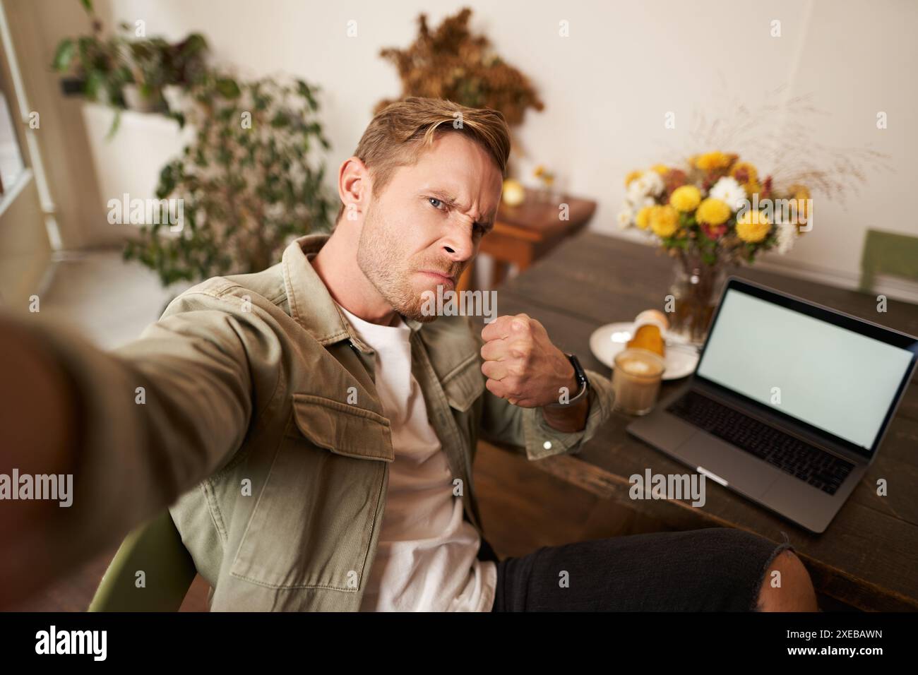 Portrait of handsome man making angry threatening face for selfie photo ...