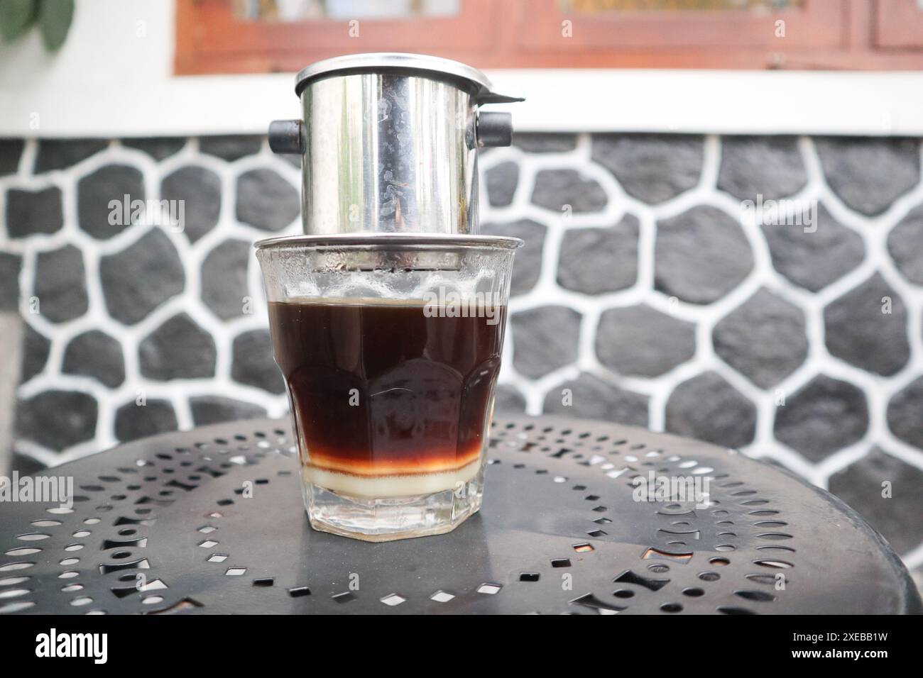 Vietnamese drip, Vietnamese coffee with condensed milk in glass cups and traditional metal ...