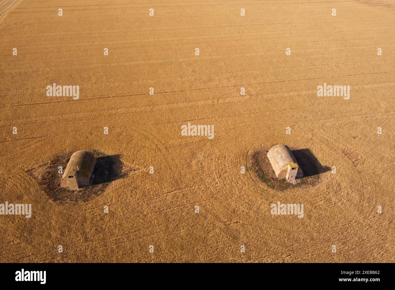 Aerial of concrete bunkers know as Igloos constructed in a wheat field ...