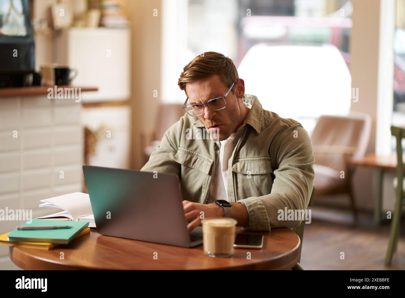 Portrait of angry man in glasses, looking frustrated and typing ...