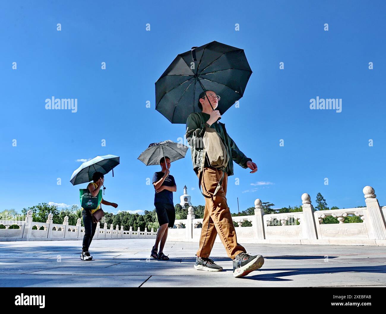 Tourists visit the Beihai Park amid hot weather in Beijing, China, 24 ...