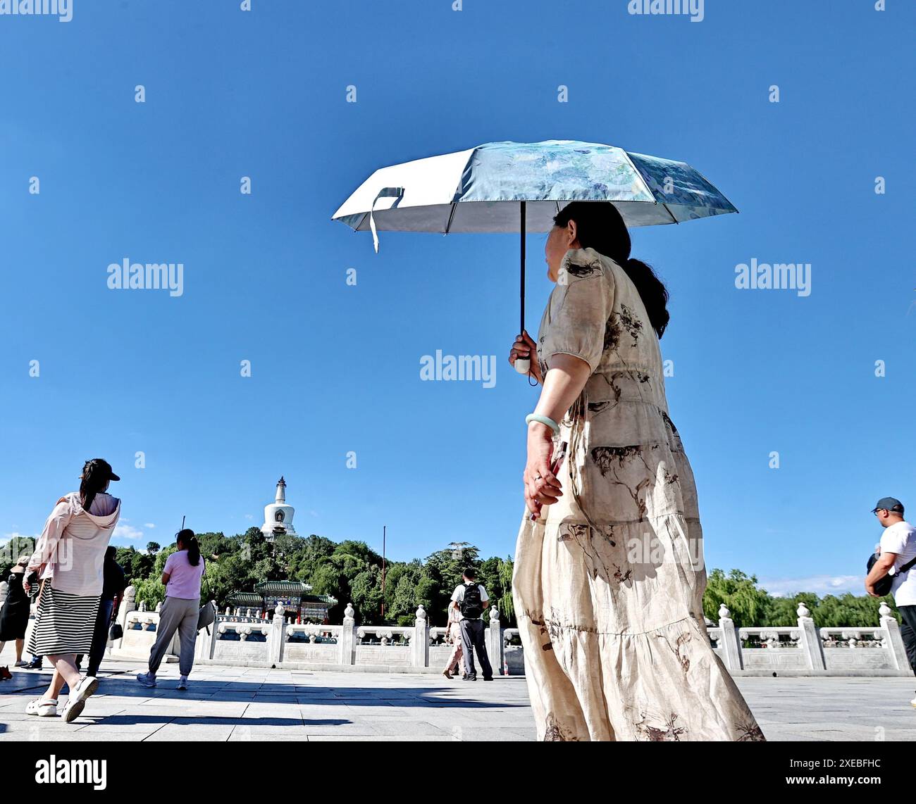 Tourists visit the Beihai Park amid hot weather in Beijing, China, 24 ...