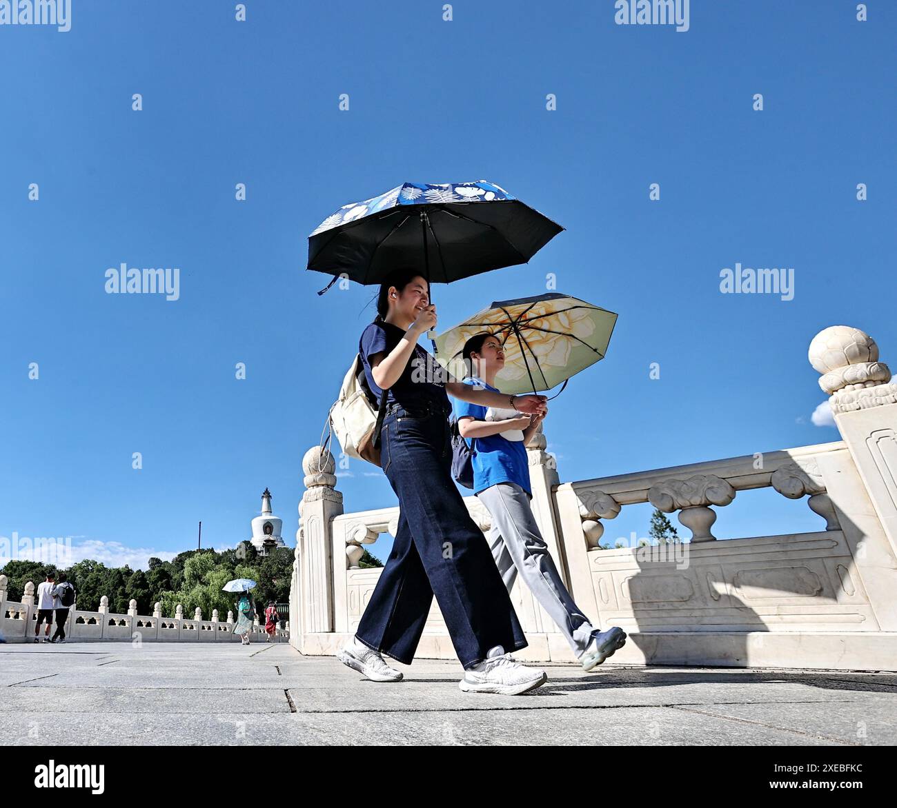 Tourists visit the Beihai Park amid hot weather in Beijing, China, 24 ...