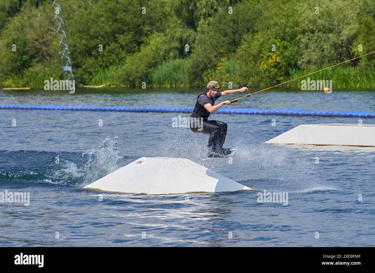 Man performing wake board tricks at Spring Lakes, Long Eaton ...