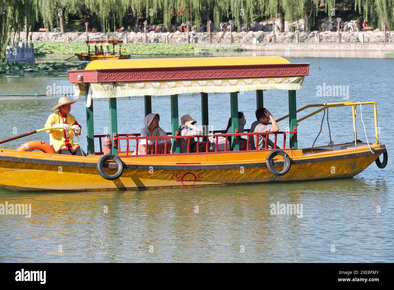 Tourists visit the Beihai Park amid hot weather in Beijing, China, 24 ...