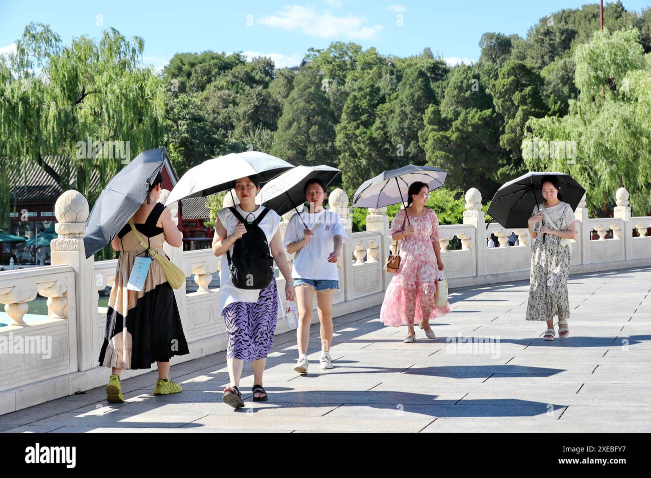 Tourists visit the Beihai Park amid hot weather in Beijing, China, 24 ...