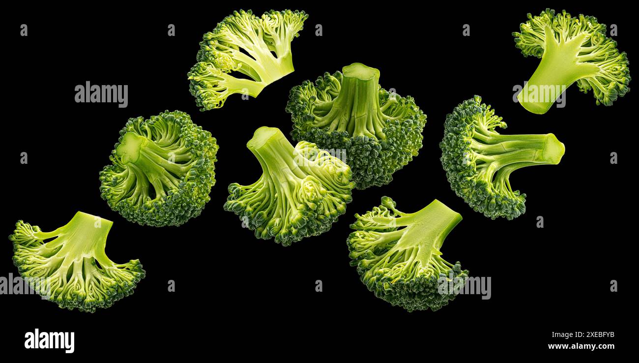 Falling broccoli on black background Stock Photo - Alamy