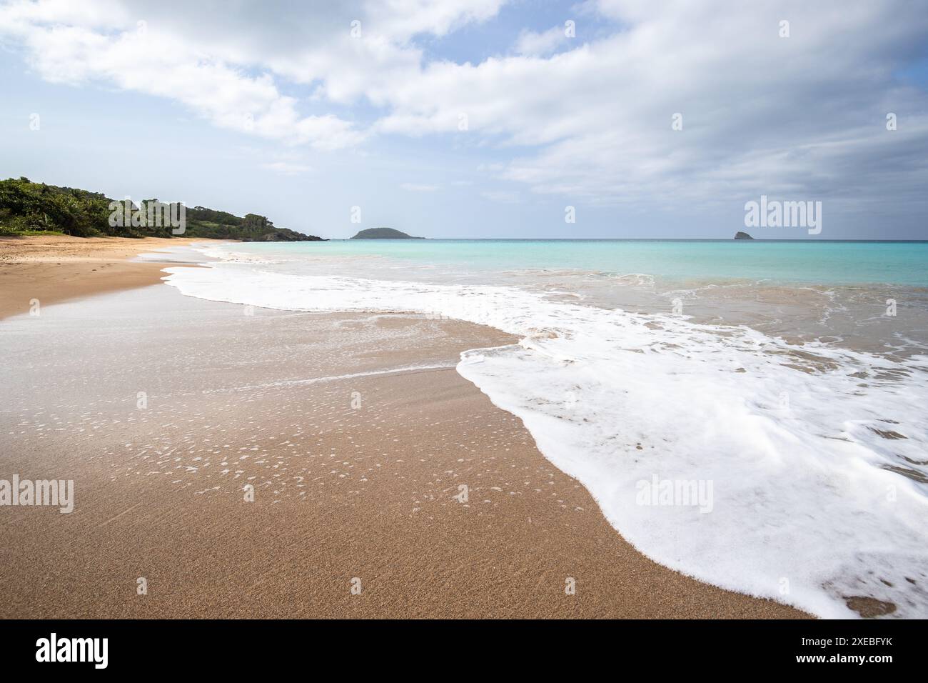 Lonely, wide sandy beach with a turquoise sea. Plage de Cluny, Basse ...