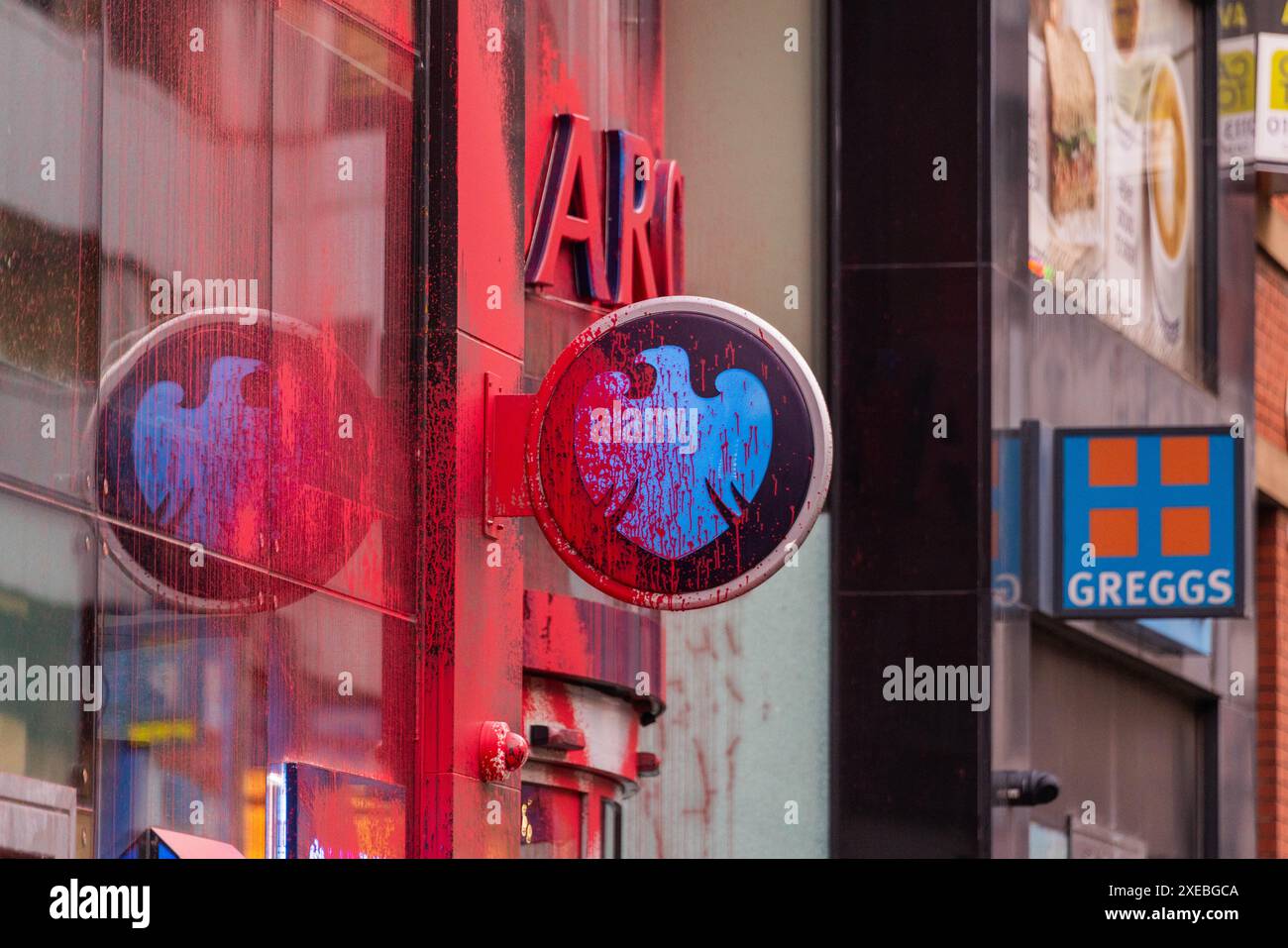 Leeds, UK. 27 JUN, 2024. Barclays logo covered in paint as direct ...
