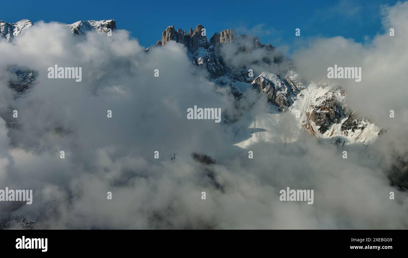 Flying through clouds between mountains Stock Photo - Alamy