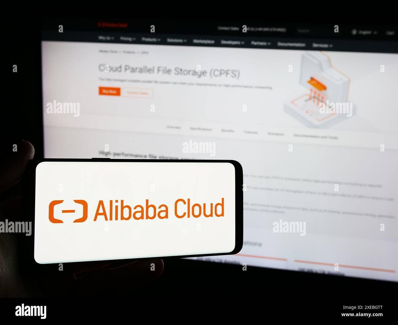 Person holding mobile phone with logo of Chinese computing company ...