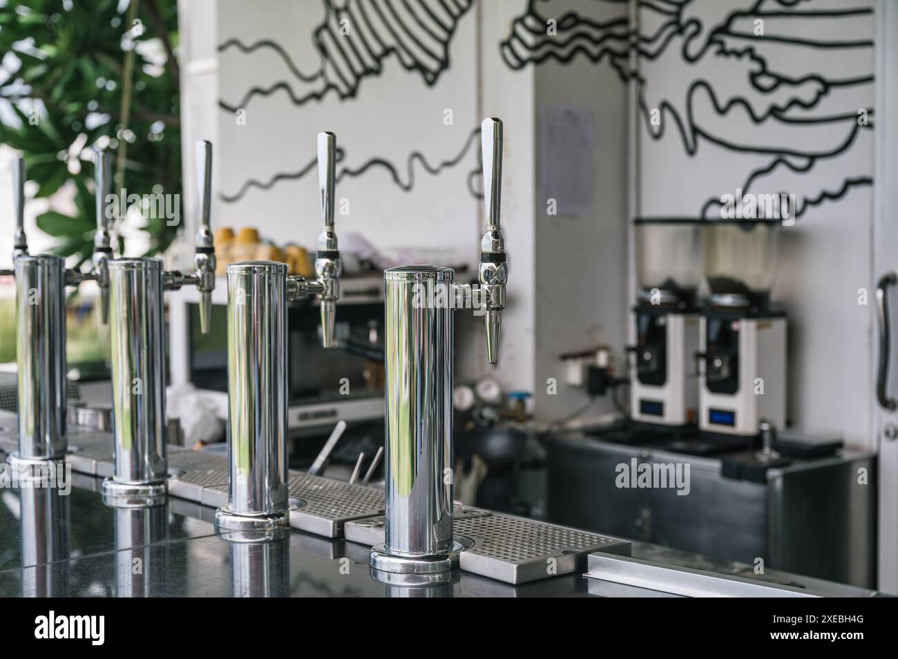 Row of stainless draft beer dispenser on counter bar Stock Photo - Alamy