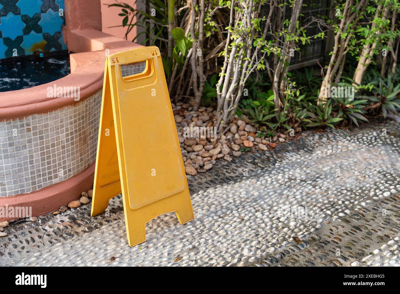 Empty yellow signboard for notification sign standing on the floor ...