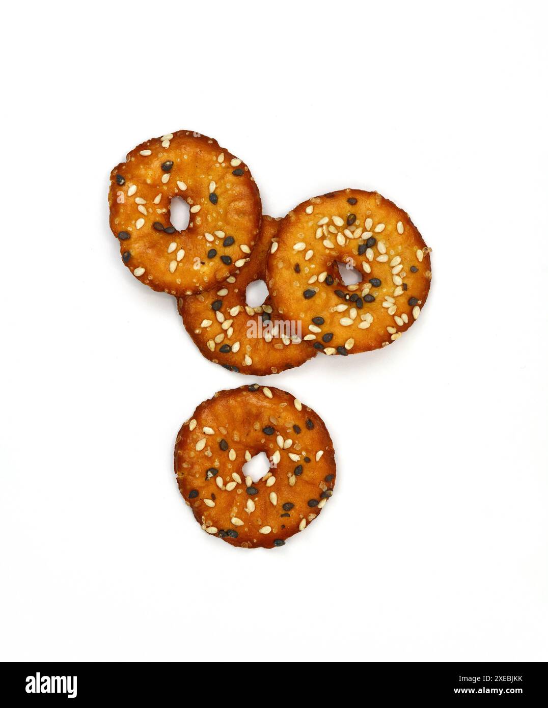 Salted round pretzels with black and white sesame isolated on white ...