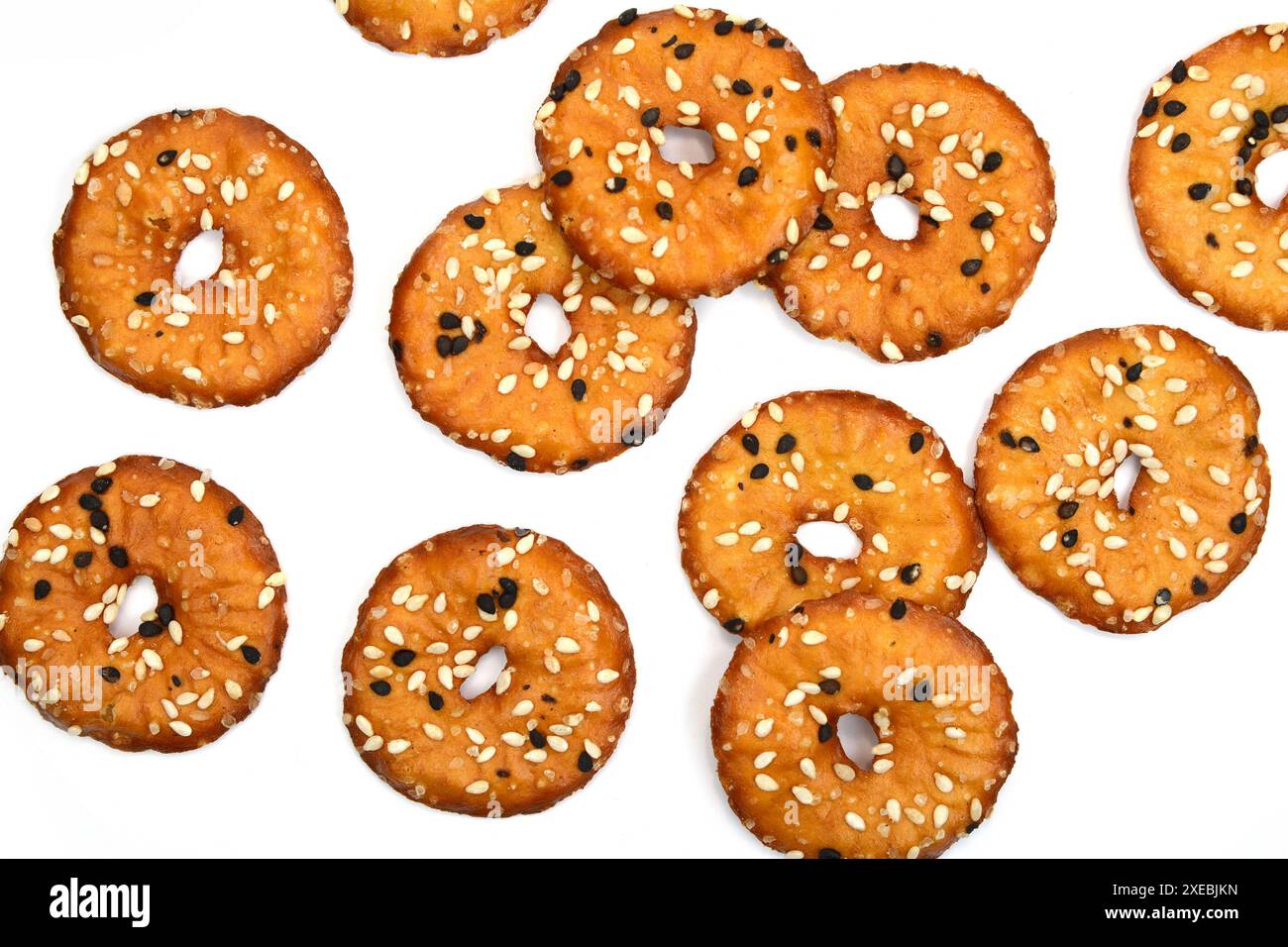 Salted round pretzels with black and white sesame isolated on white ...