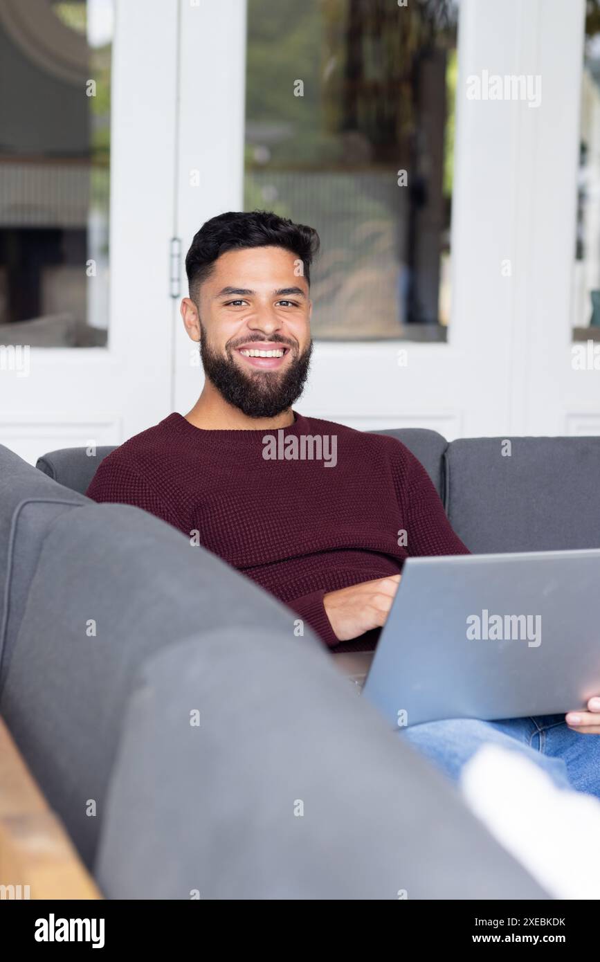 Man sitting on couch using hi-res stock photography and images - Alamy