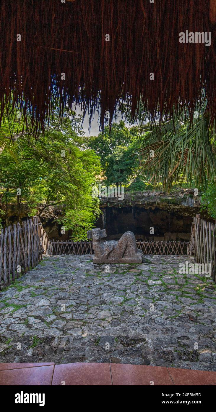 Mayan sculpture Chac Mool at the entrance of cenote Zaci in Yucatan ...
