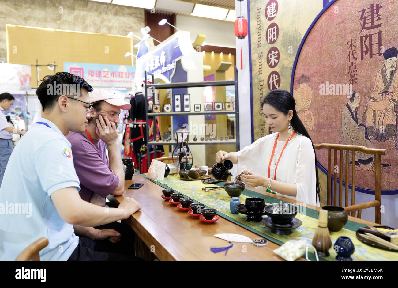 Fuzhou, China's Fujian Province. 26th June, 2024. Guests watch a tea ...
