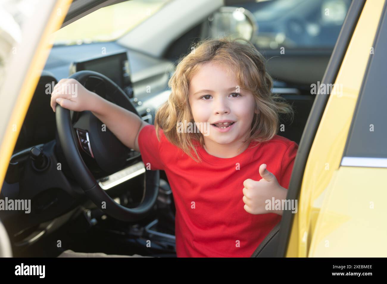 Little Driver. Cute little boy pretending to drive. Kid in car with his ...