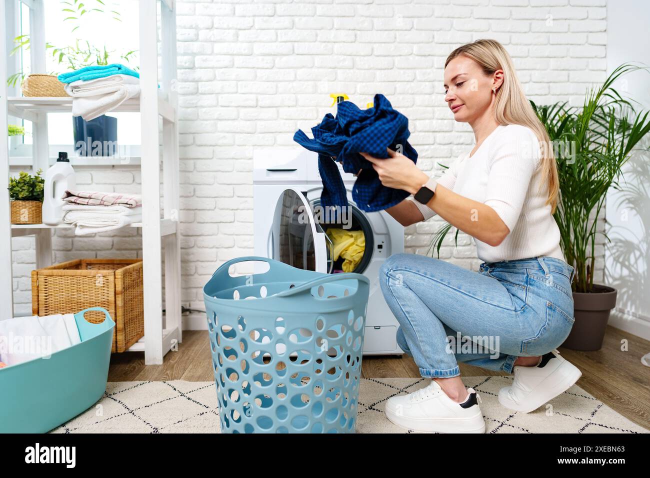Woman sorting laundry washing machine hi-res stock photography and ...