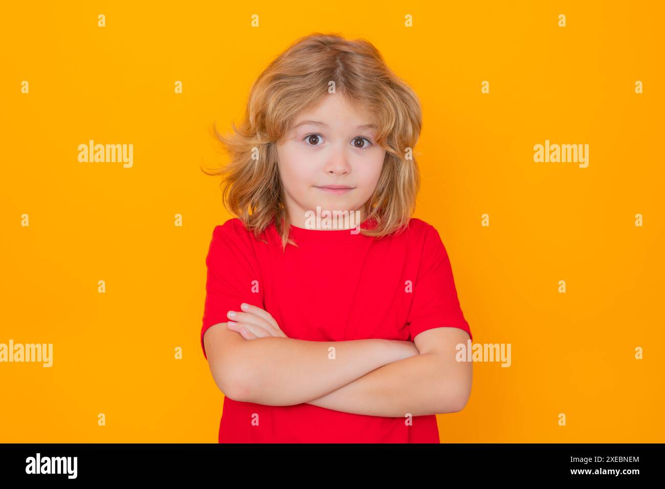 Portrait of child with crossed arms on isolated studio background Stock ...