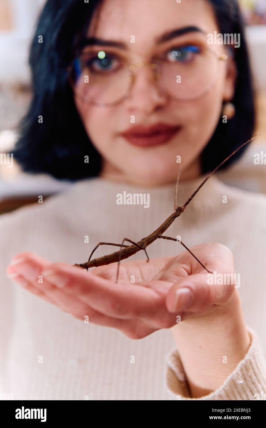 Young Woman Captured in a Beautiful Moment with Her Stick Insect ...