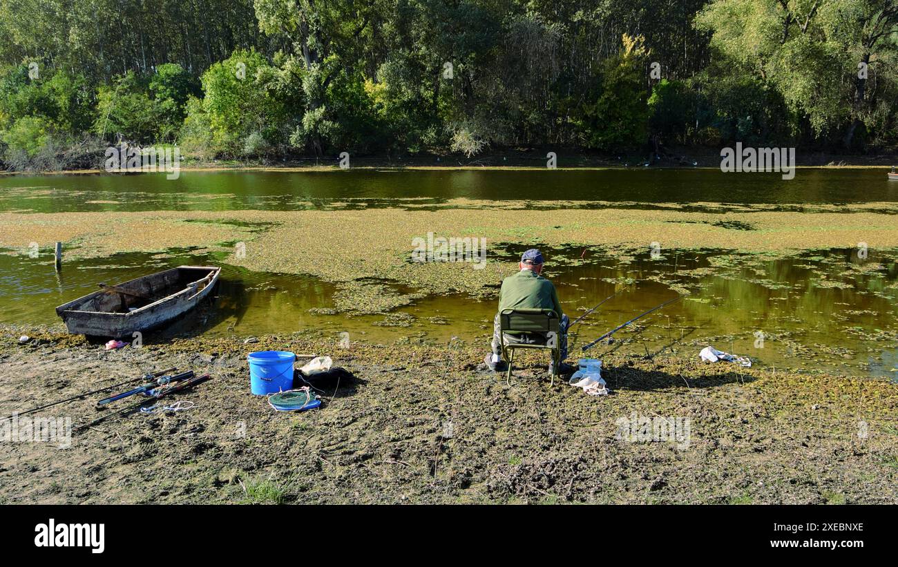 man fishing from the bank of Special Nature Reserve "Koviljsko ...