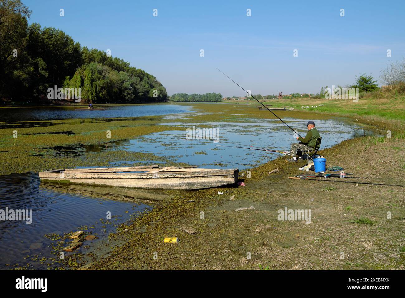 man fishing from the shore of Special Nature Reserve "Koviljsko ...
