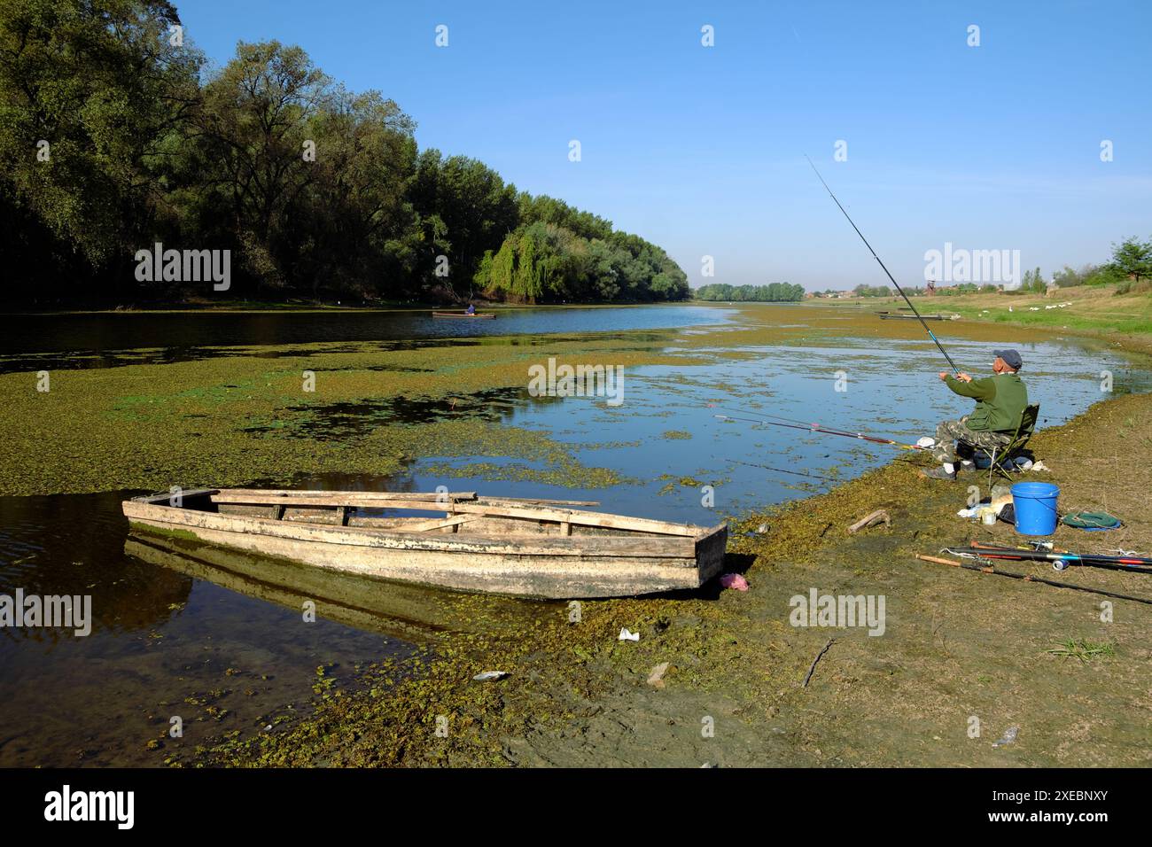 man fishing from the shore of Special Nature Reserve "Koviljsko ...