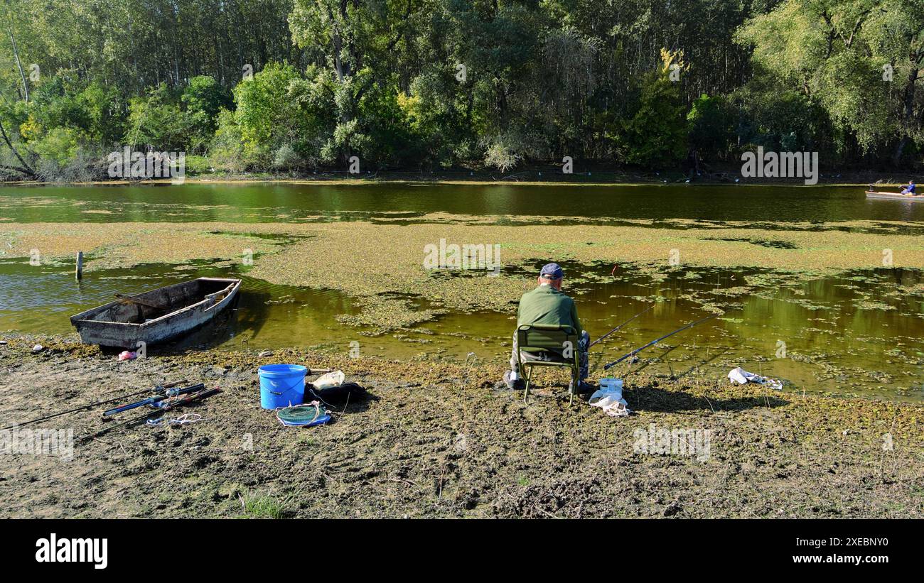 man fishing from the bank of Special Nature Reserve "Koviljsko ...