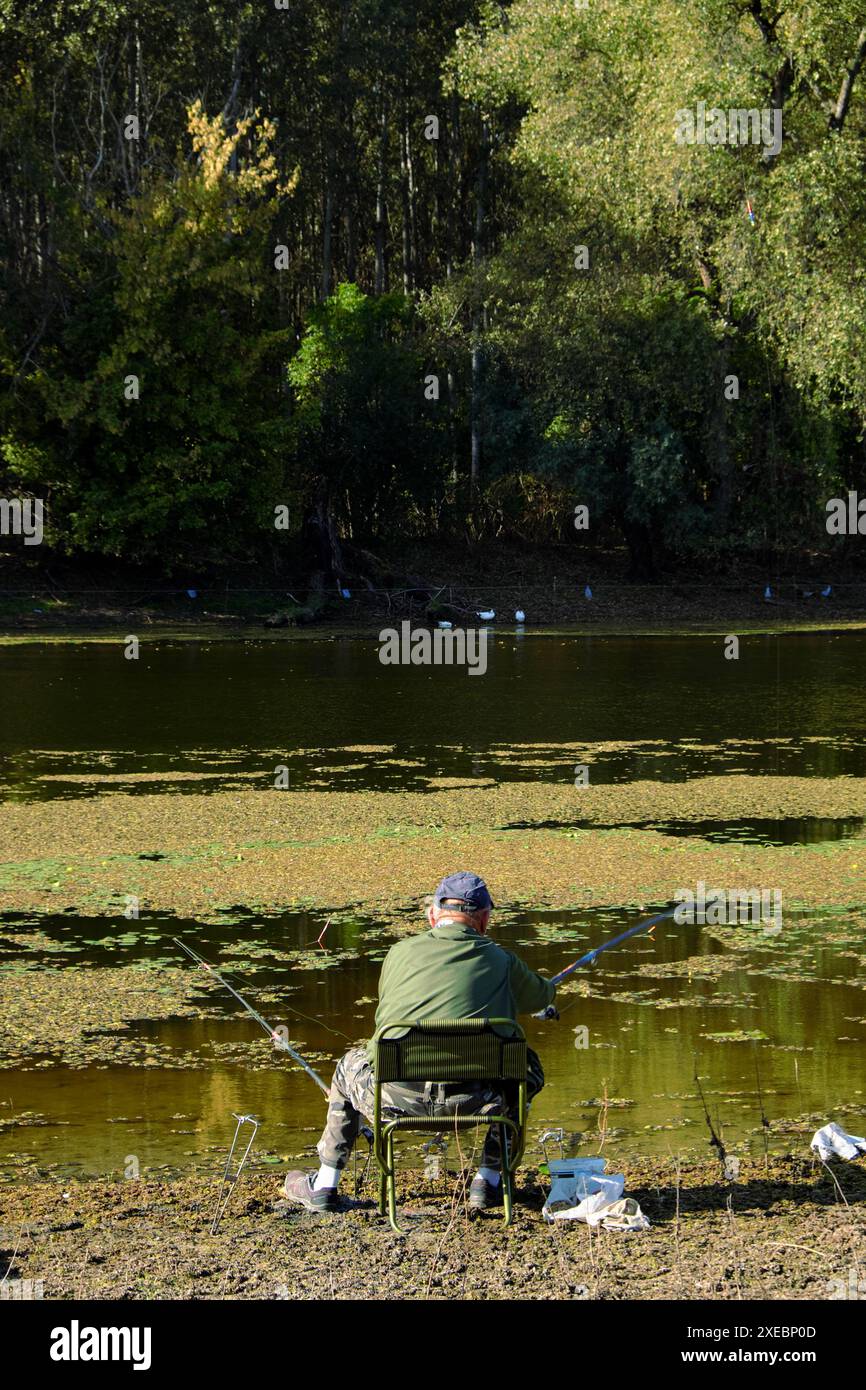 man fishing from the bank of Special Nature Reserve "Koviljsko ...