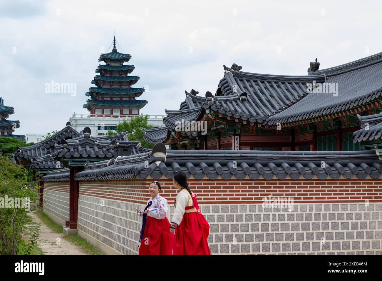 Elegant Korean woman in hanbok strolls through an ancient palace in ...