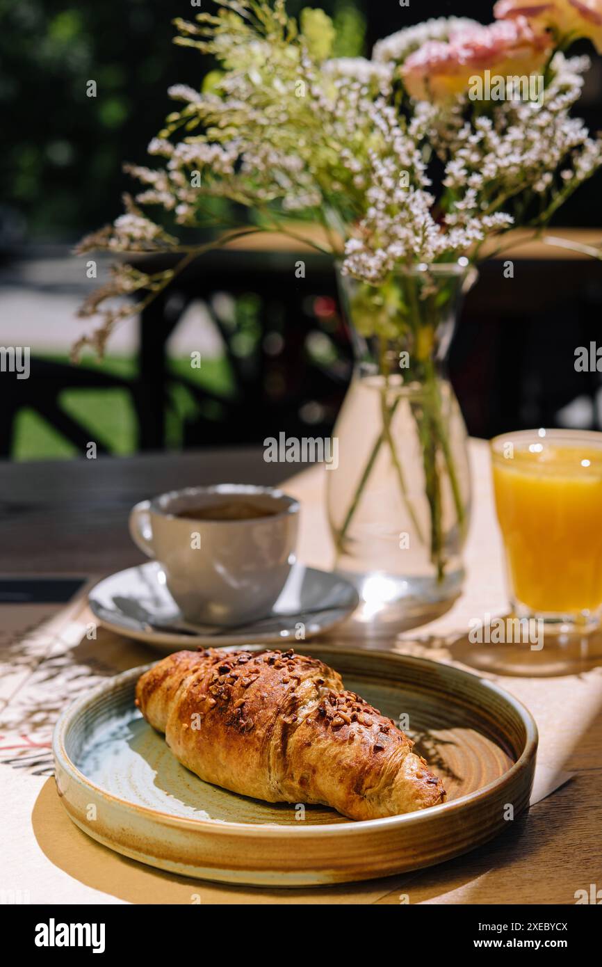 Cup of fresh hot coffee, orange juice and traditional french croissant ...