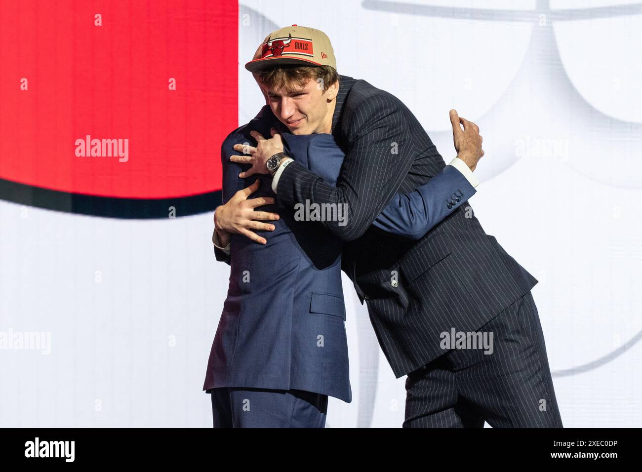 Commissioner Adam Silver shakes hands with Matas Buzelis, selected as ...