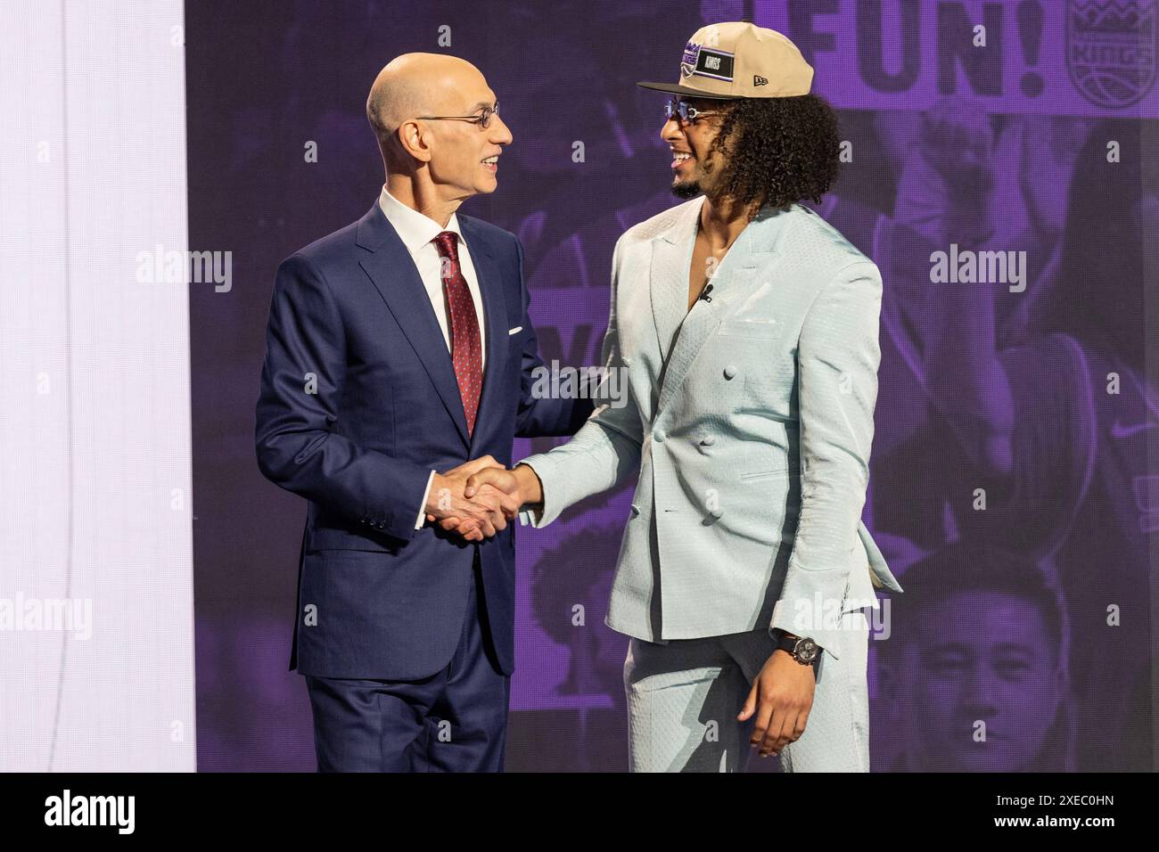 Commissioner Adam Silver shakes hands with Devin Carter, selected as ...