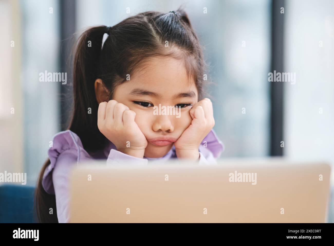 Young Girl Bored with Online Learning Stock Photo - Alamy