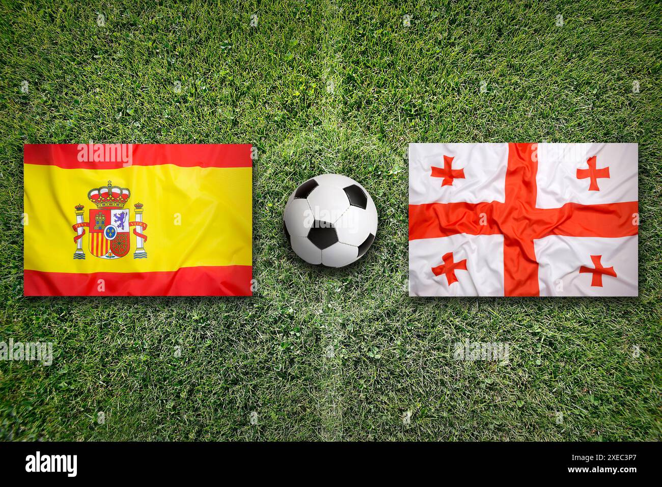 Spain vs. Georgia flags on green soccer field or football field Stock ...